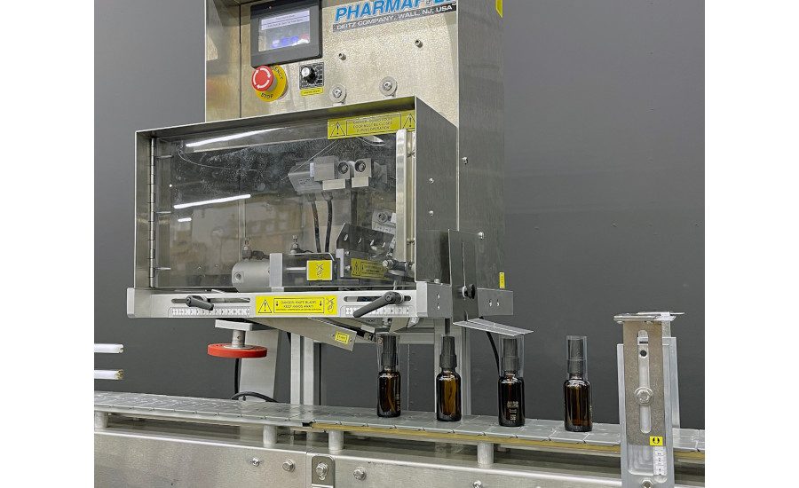 Neck banding machine from Deitz Co. automatically applies shrinkbands ...